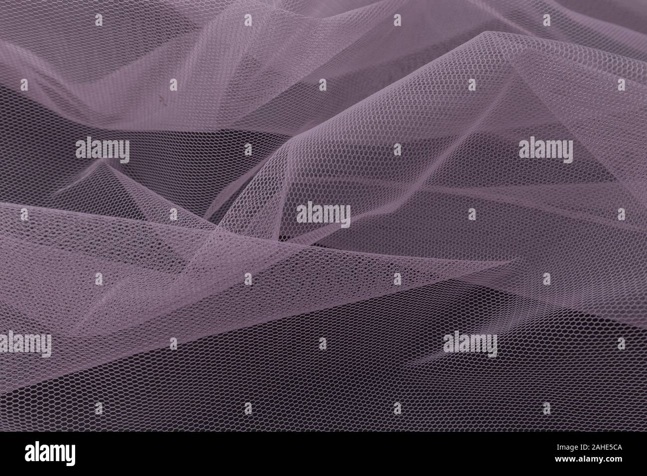 Beautiful close up of lila tulle fabric with textile texture background ...