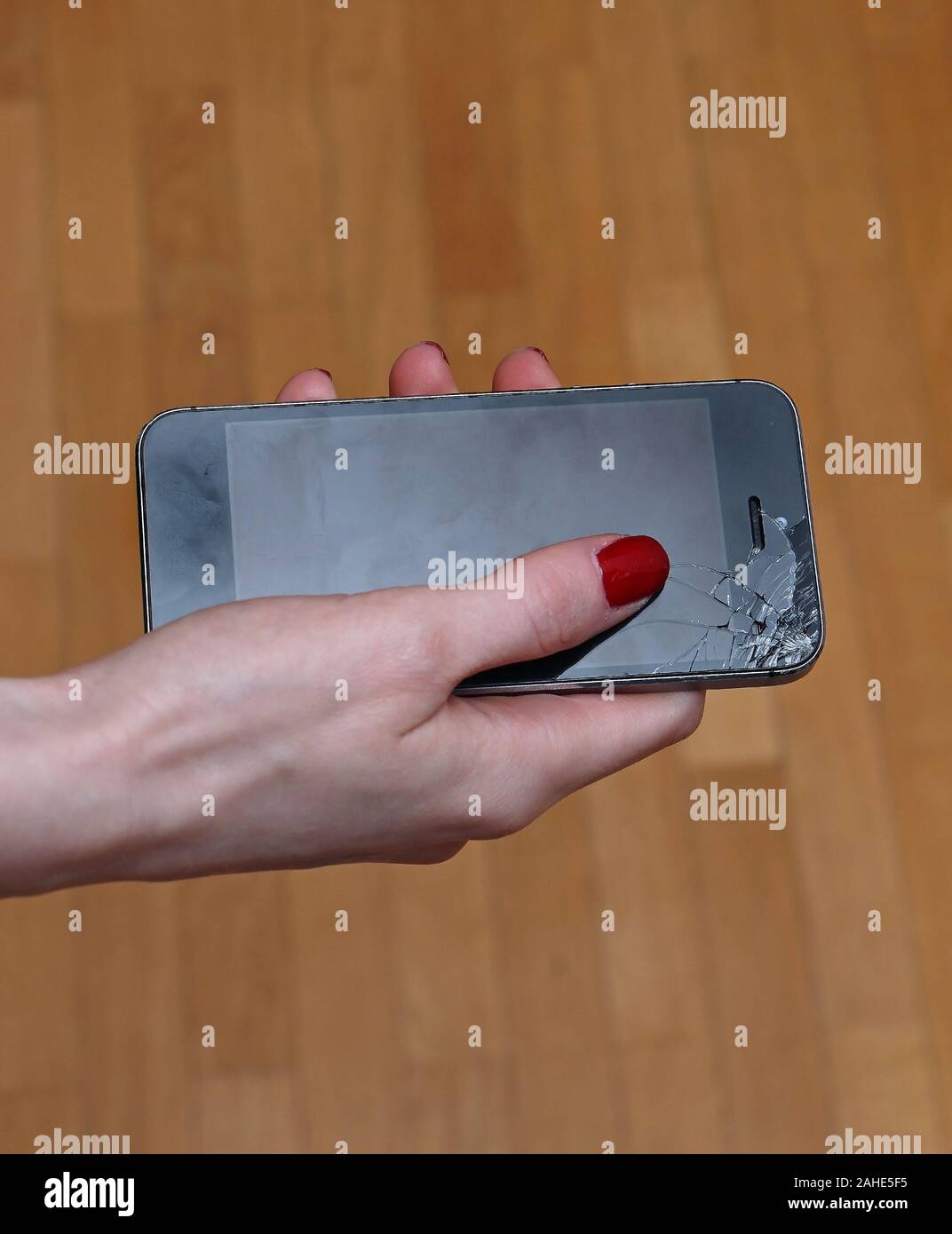 Female hand holding dropped smart phone with broken screen Stock Photo ...