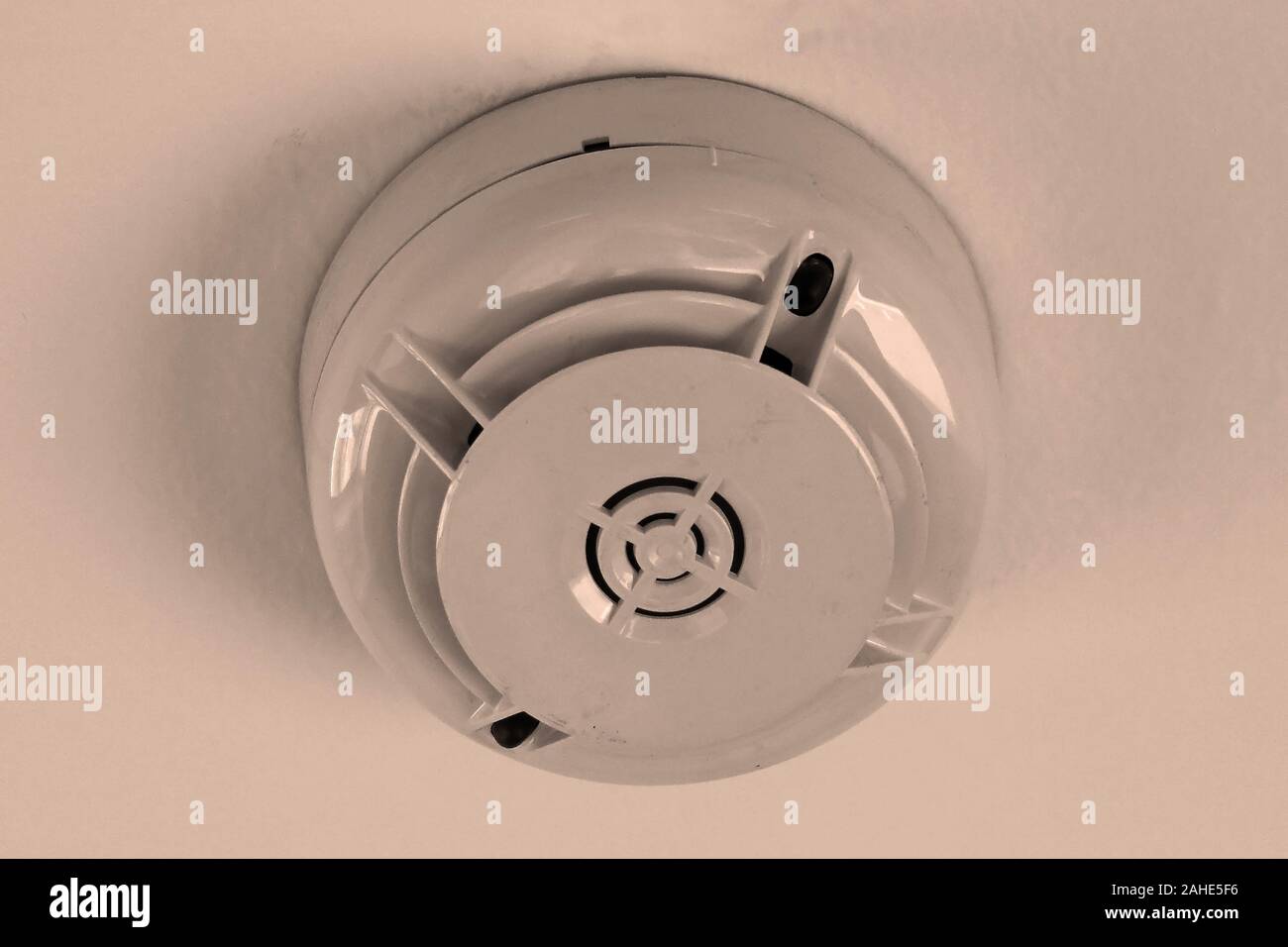 Modern fire alarm device on house ceiling Stock Photo - Alamy