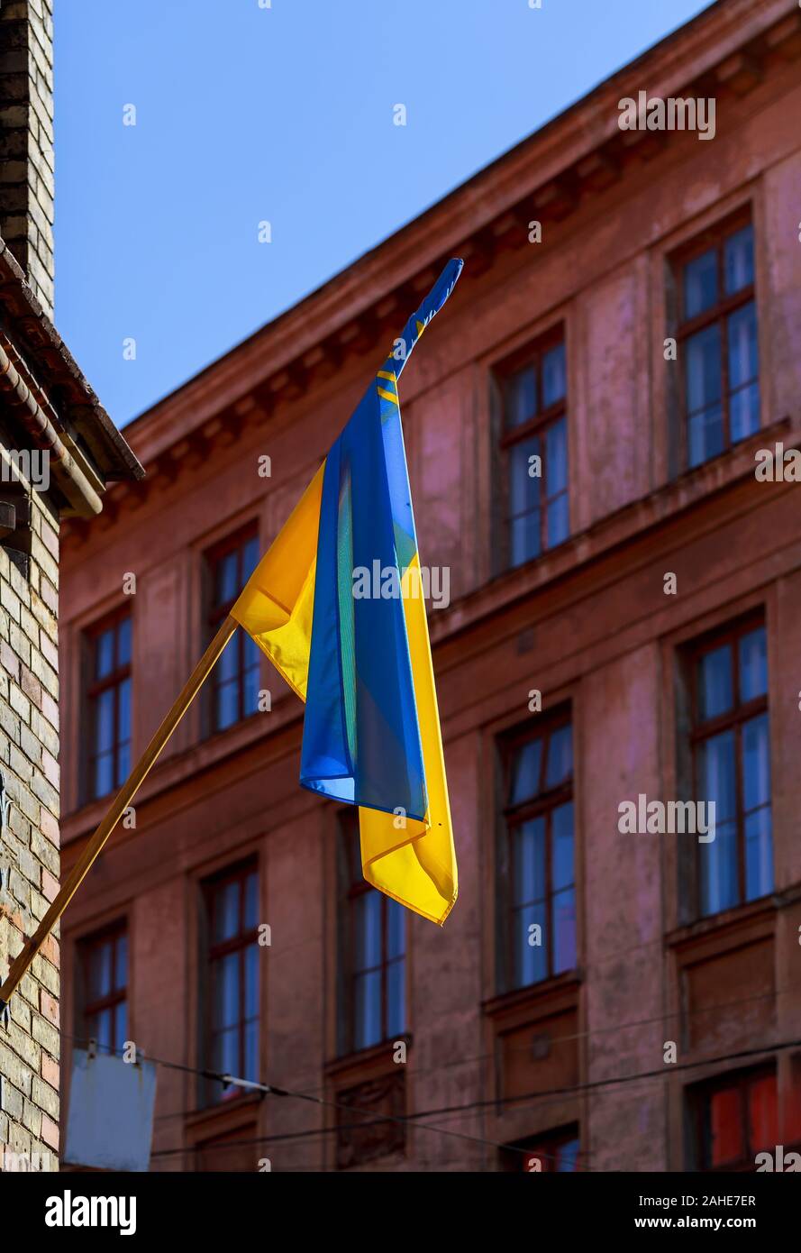 Ukrainian yellow blue flag waving on a flagpole of the building Stock ...