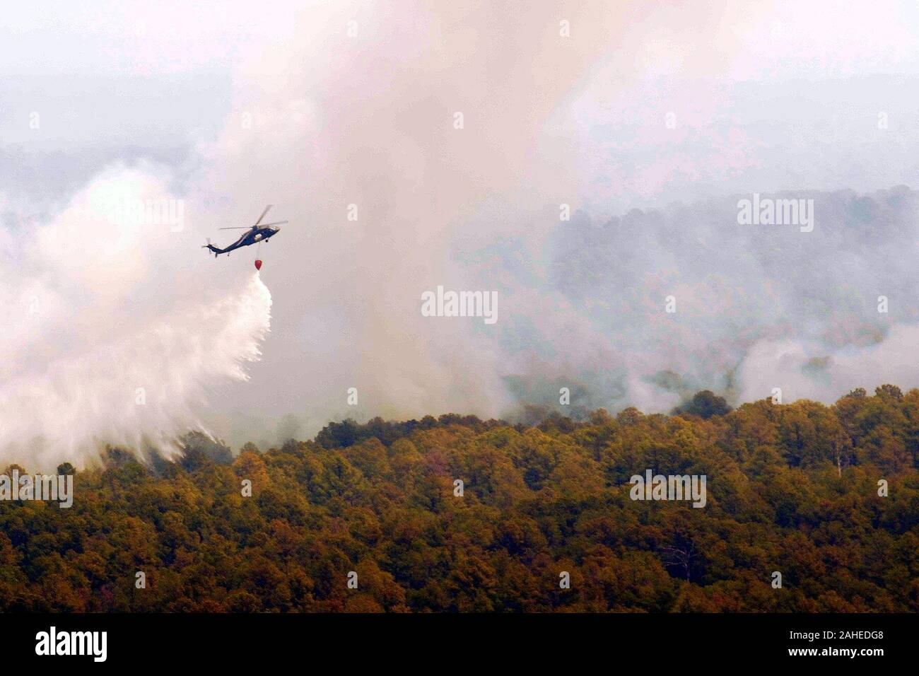 A Texas National Guard UH-60 Blackhawk helicopter released water from ...