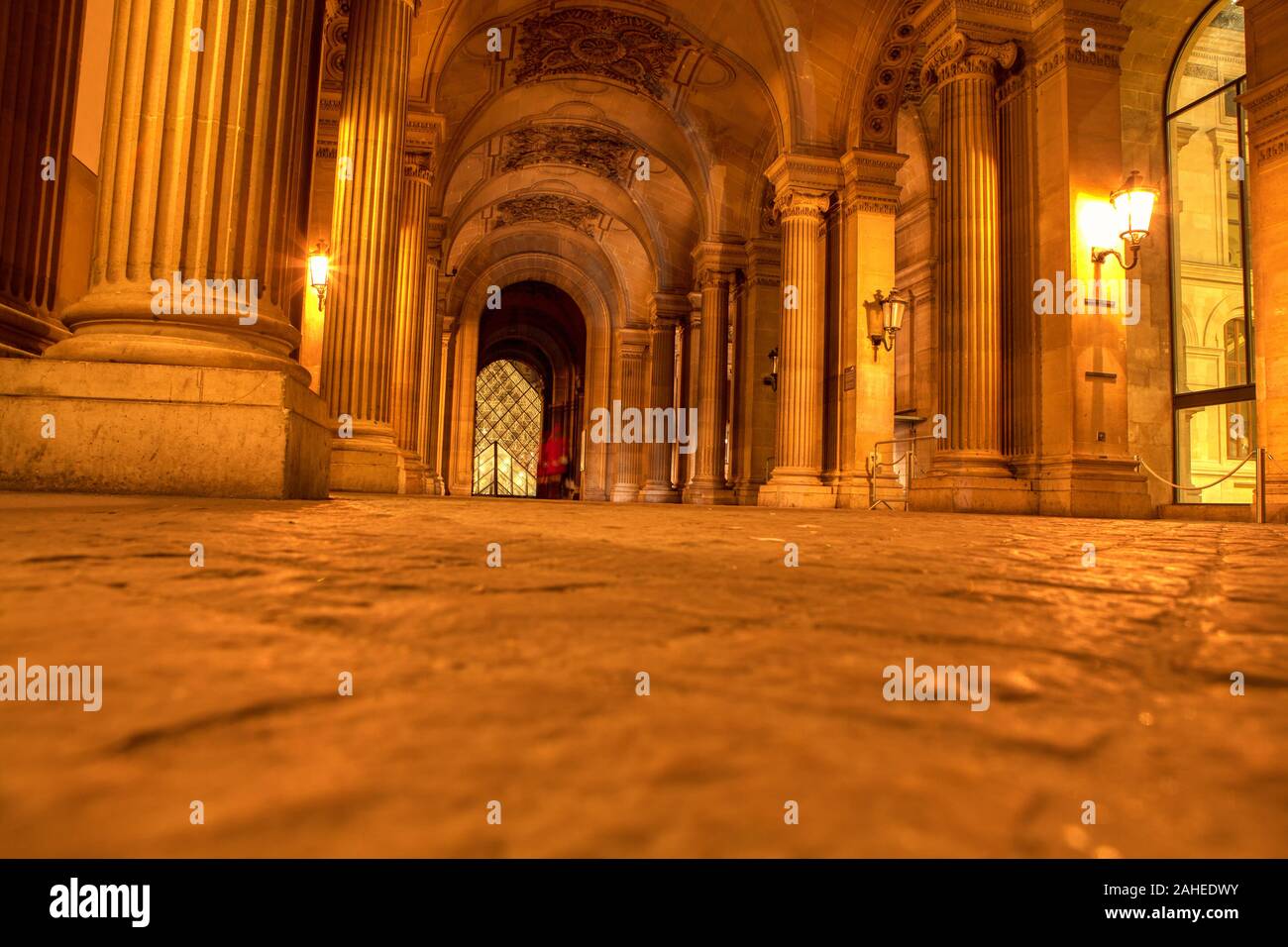 Arch gallery with columns illuminated in the night Stock Photo - Alamy