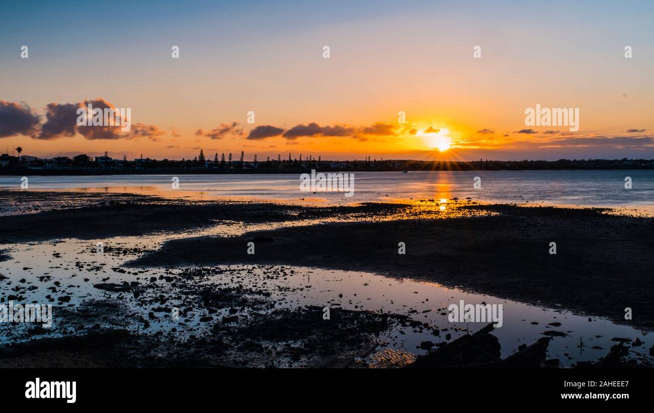 Sunset on the beach at clevelands queensland australia Stock Photo - Alamy