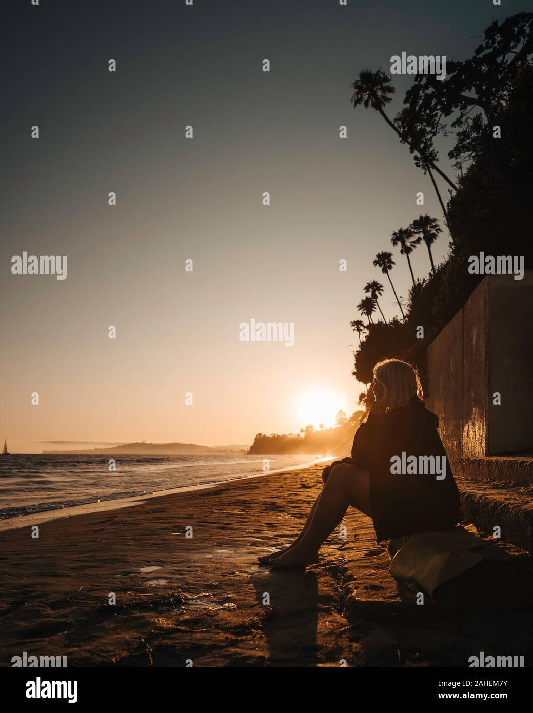 Women watches the sunset at the Beach Stock Photo - Alamy