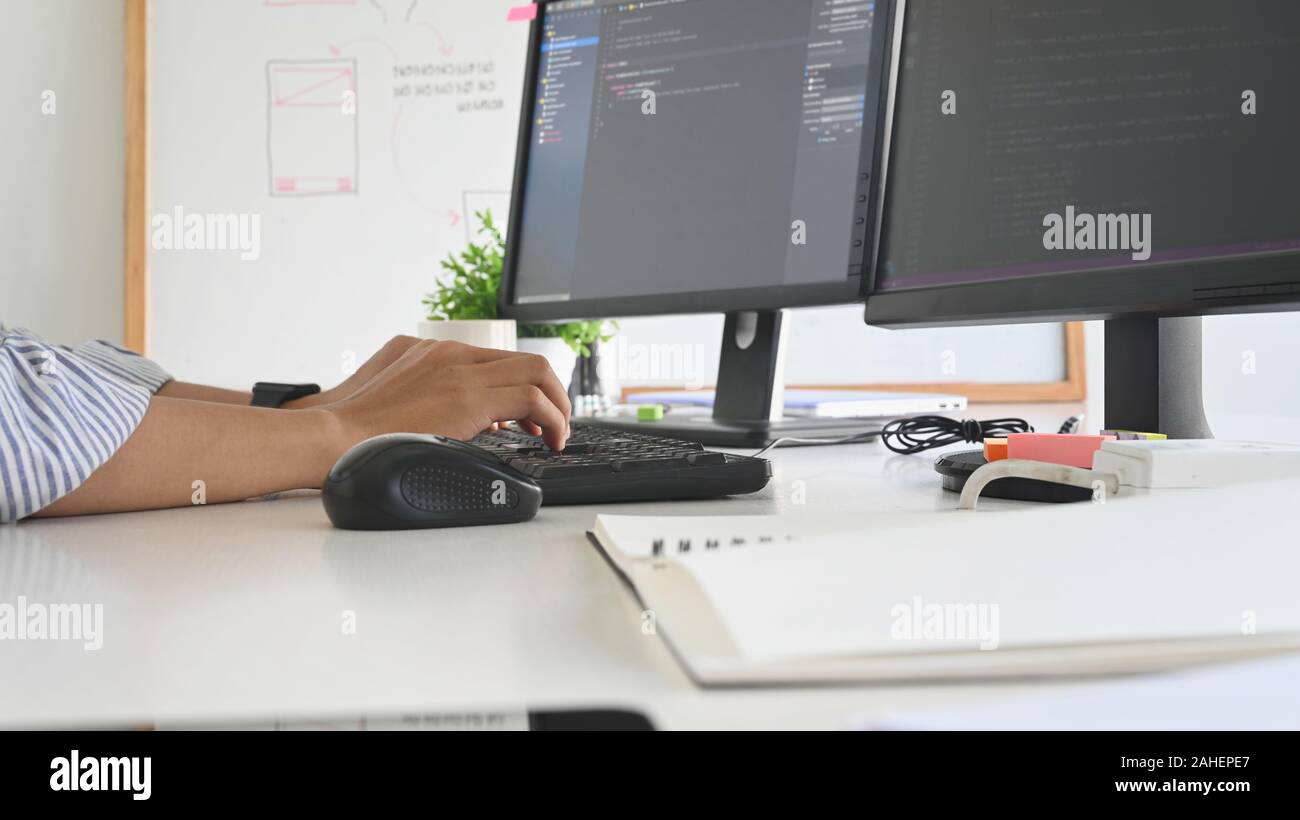 Closeup programmer working with his computer Stock Photo - Alamy