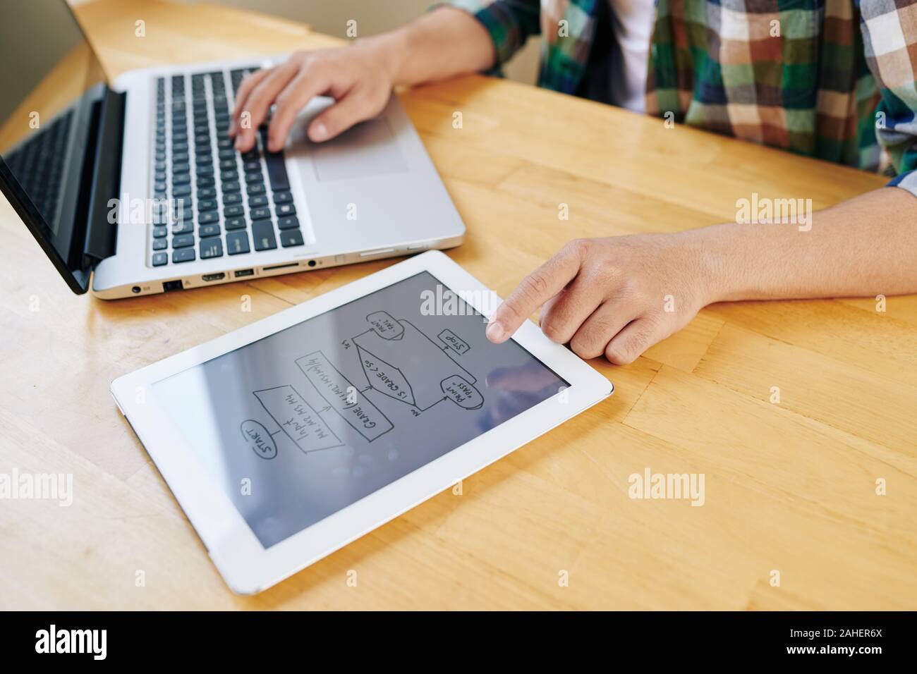 hands of student following flowchart diagram representing computer program project Stock Photo ...