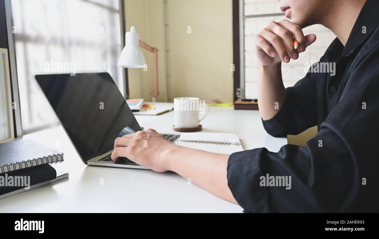 Side view man's hands using laptop computer and thinking ideas on home ...