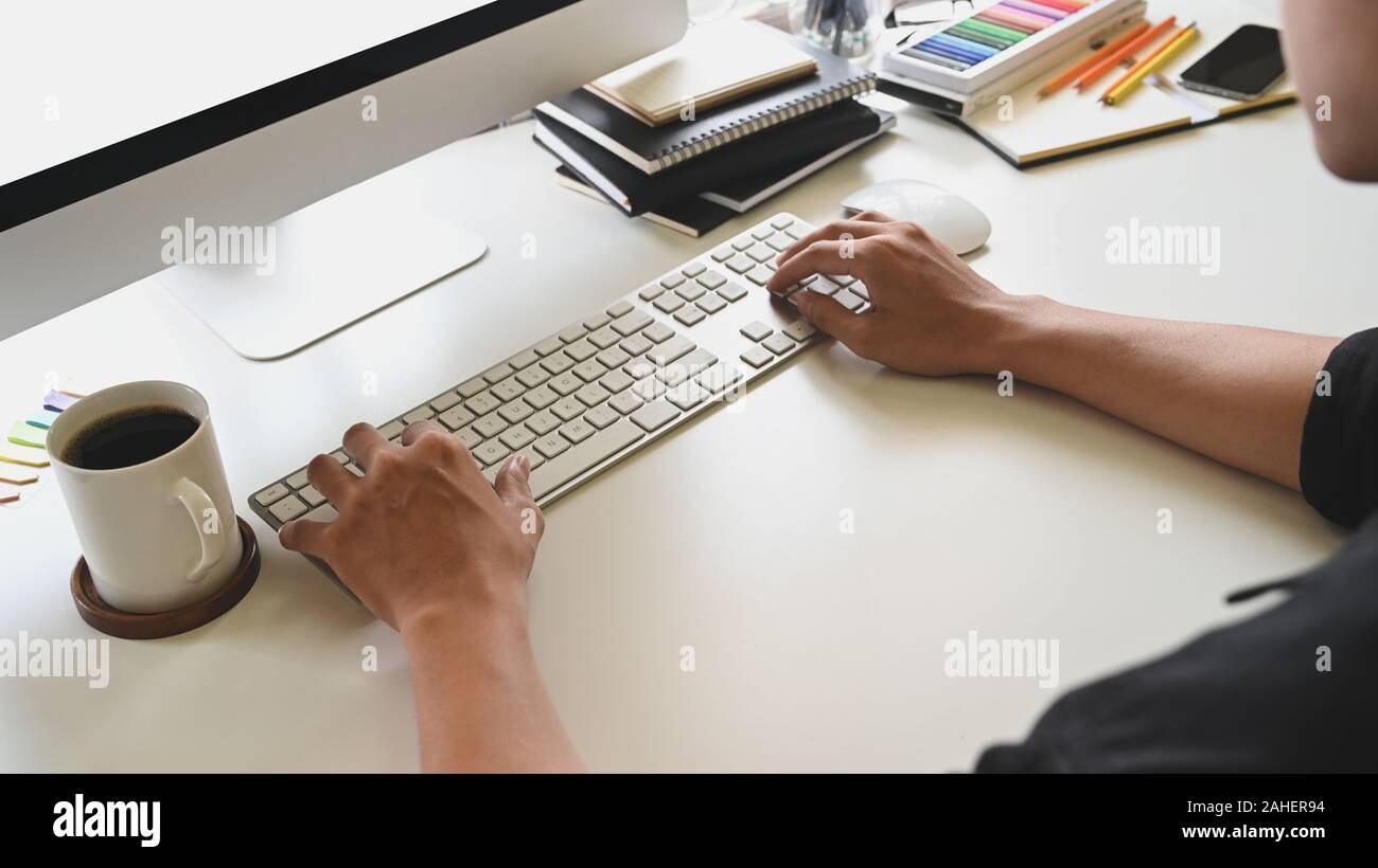 Top view man's hands using computer on home office with cropped shot ...