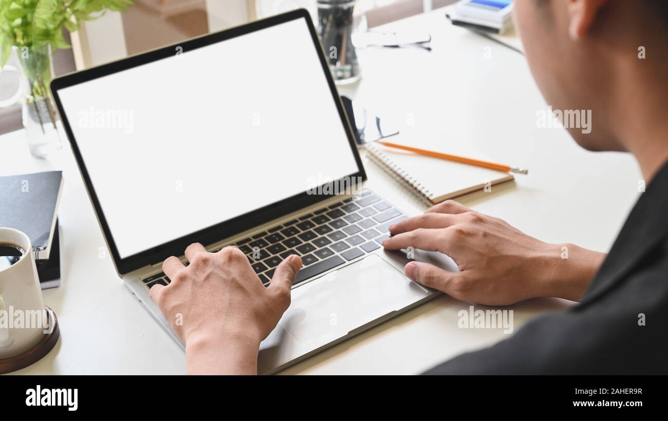 Side view man's hands using laptop computer on home office with cropped ...