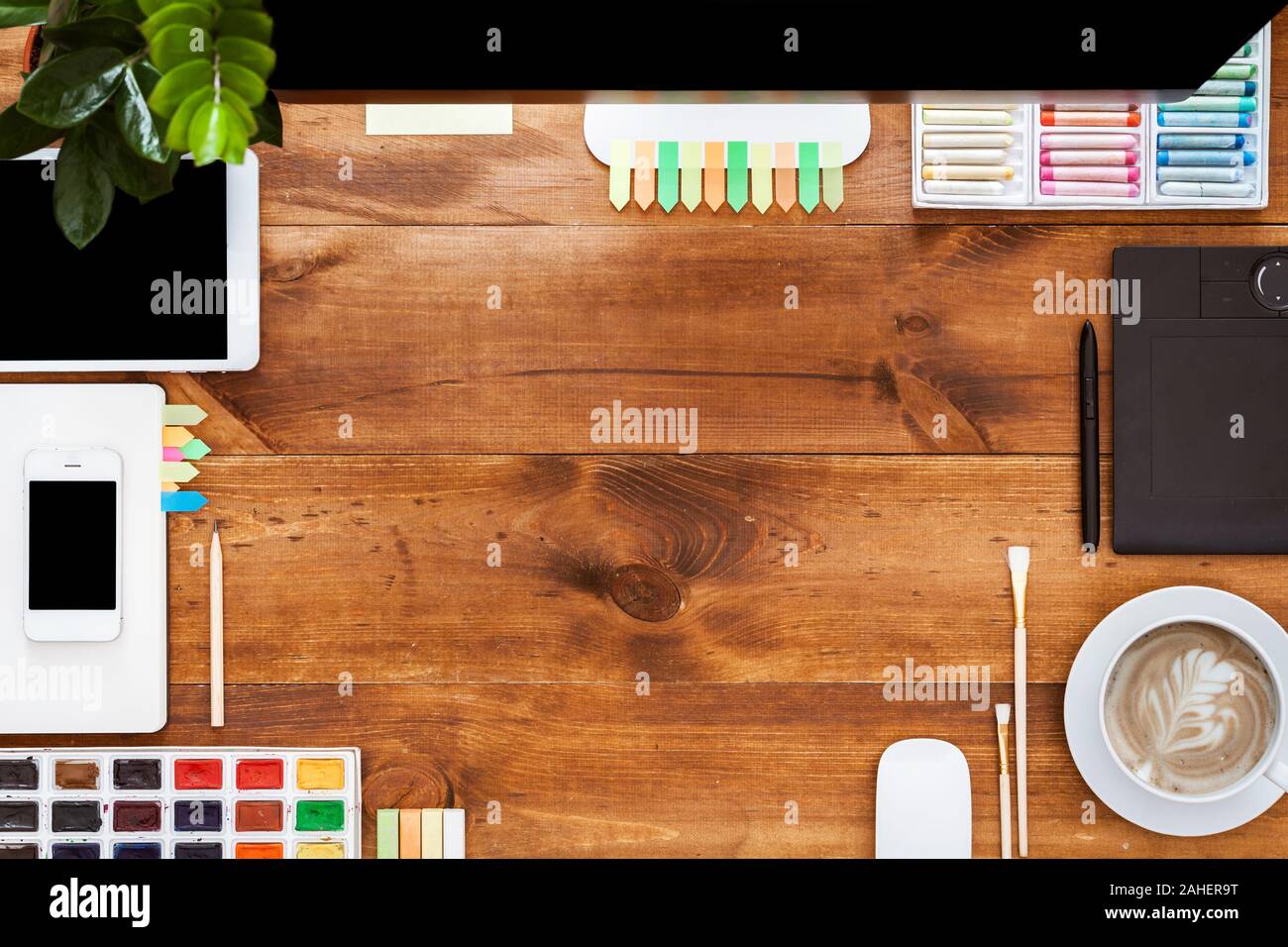 Design creative worktable concept, computer paints on brown wooden desk ...