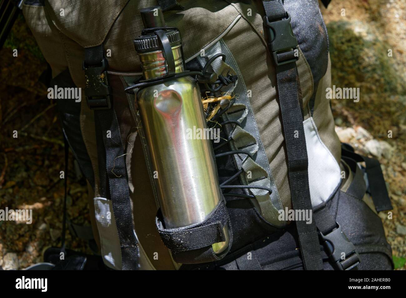 A stainless steel drink bottle on the back of a hiking backpack Stock ...