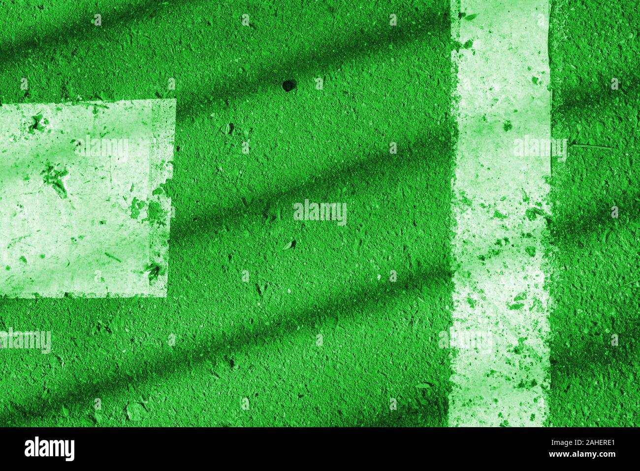 Asphalt surface with white paint and shadow. Abstract background green ...