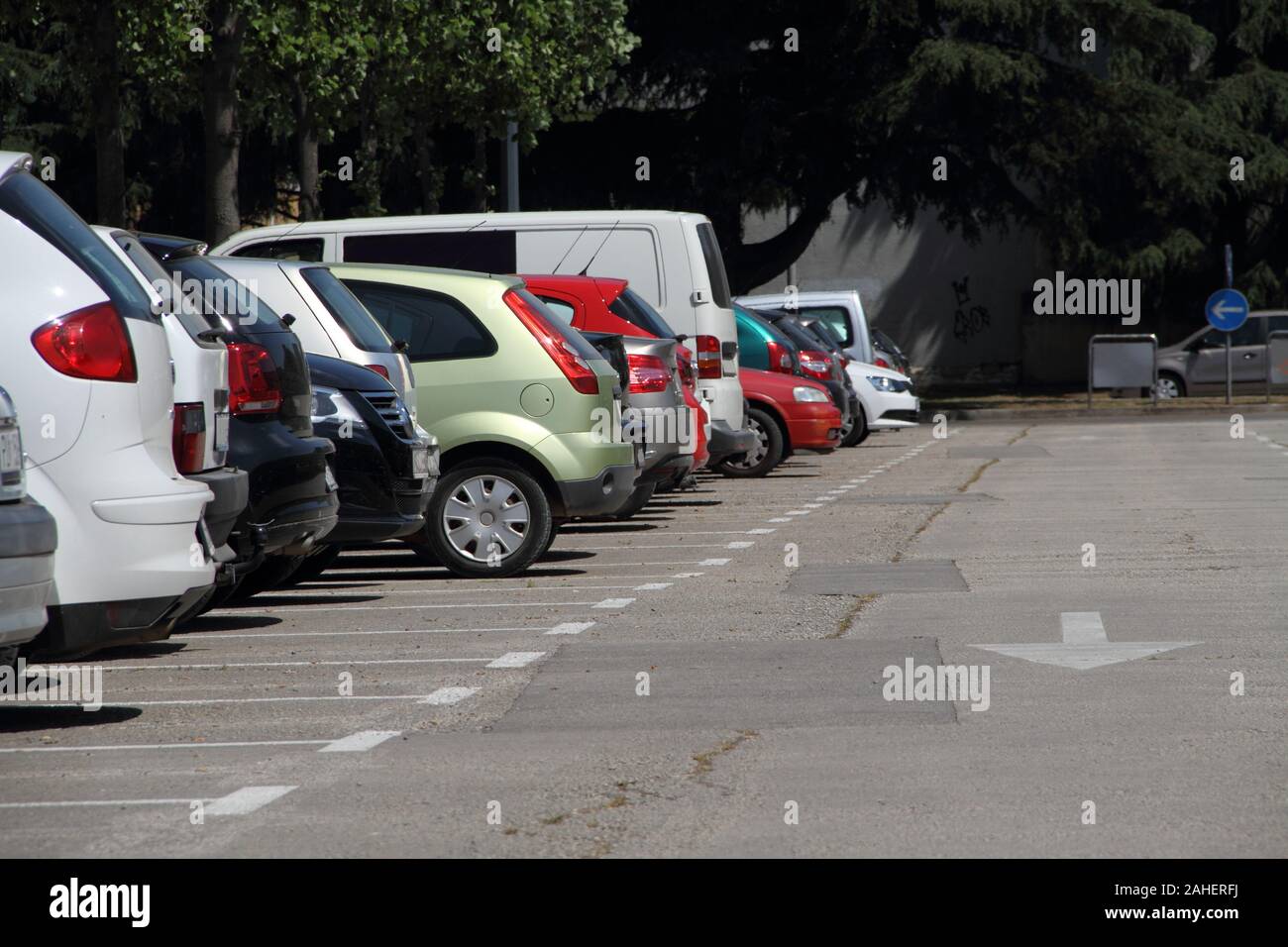 a row of cars in a parking lot Stock Photo - Alamy