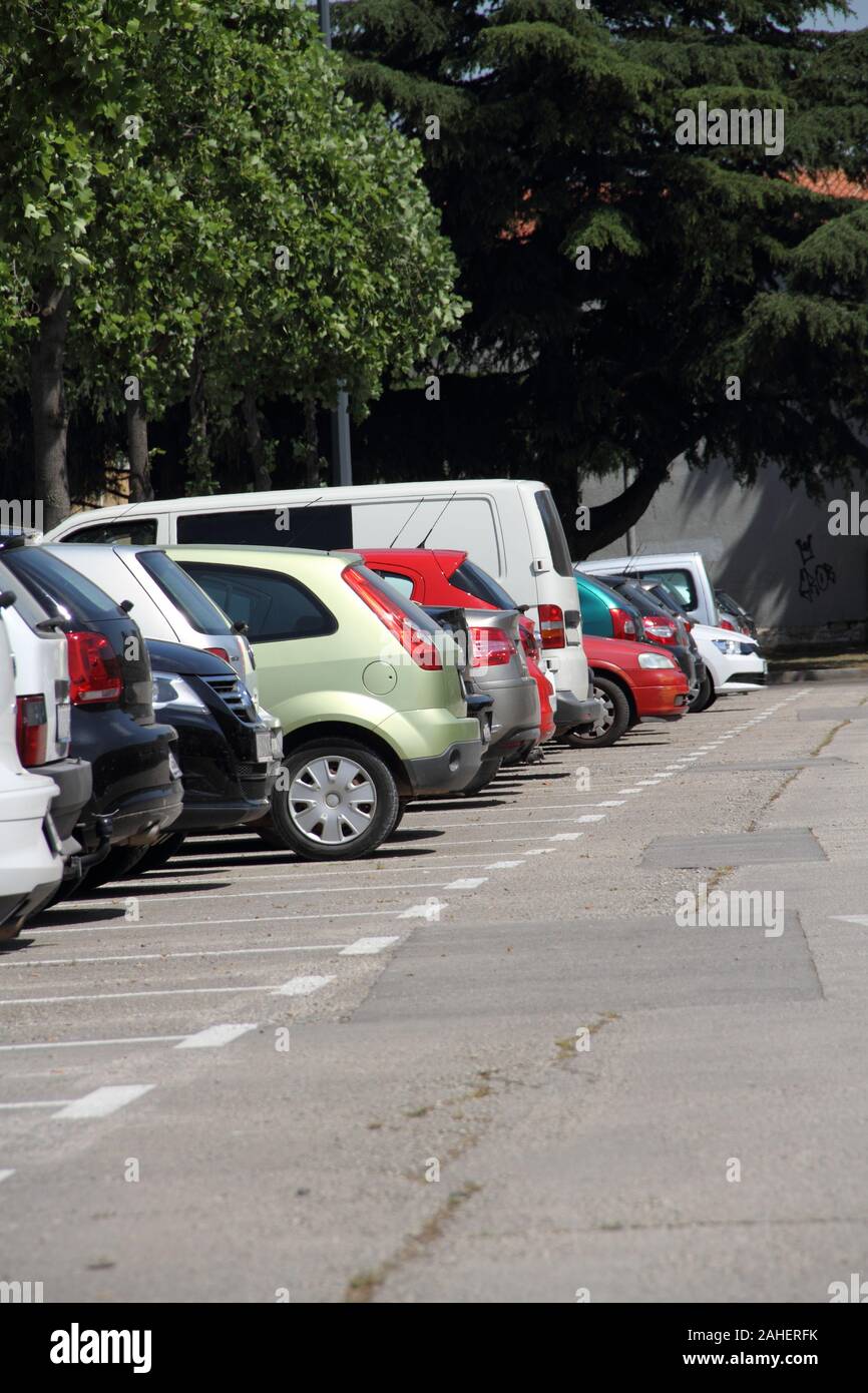 a row of cars in a parking lot Stock Photo - Alamy
