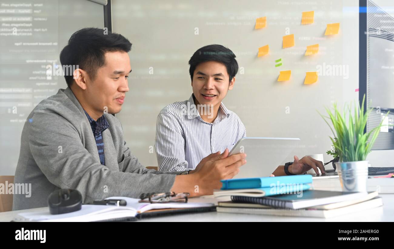 Professional programmers meeting they computer equipment on workplace ...