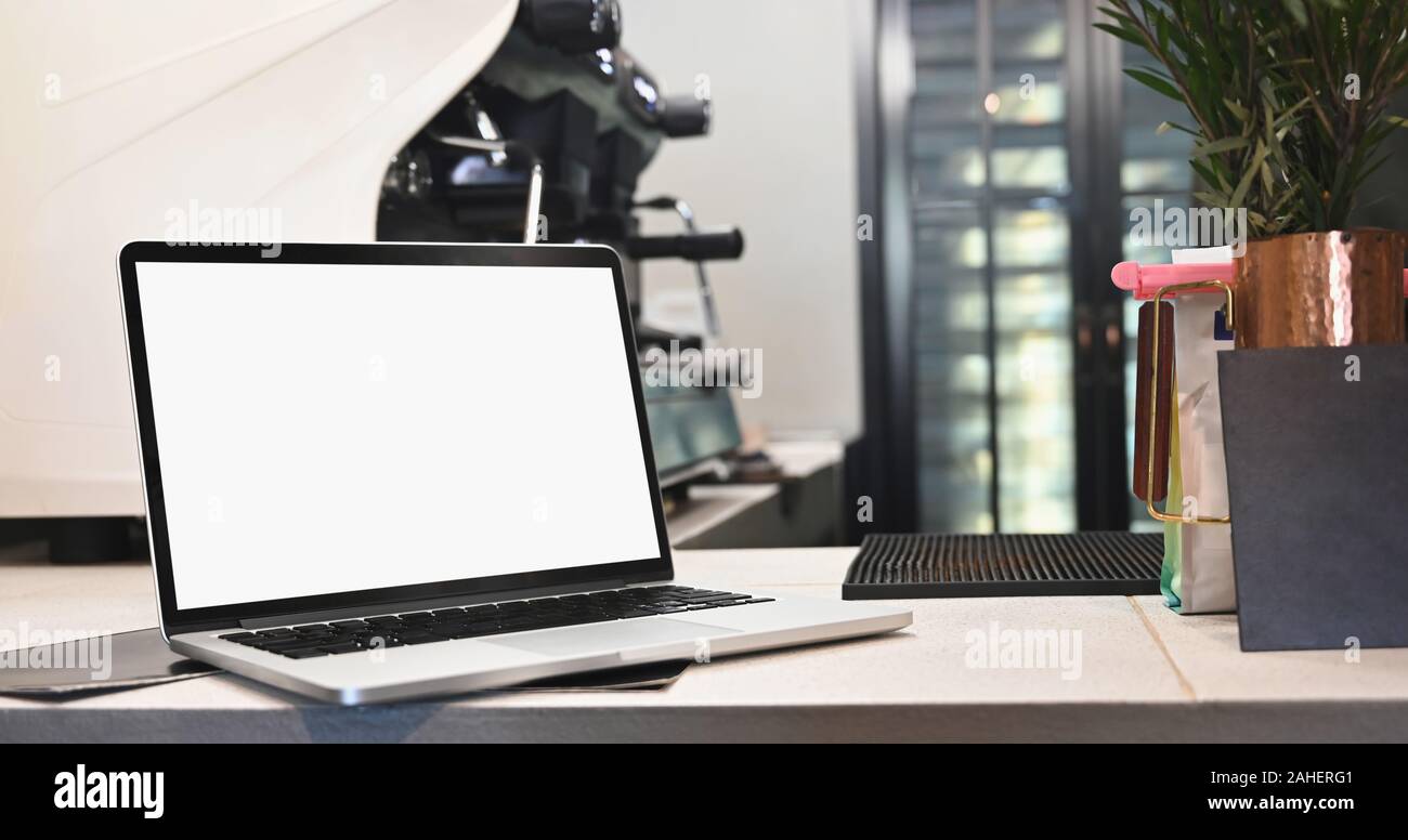 Mockup laptop computer on counter bar coffee shop Stock Photo - Alamy