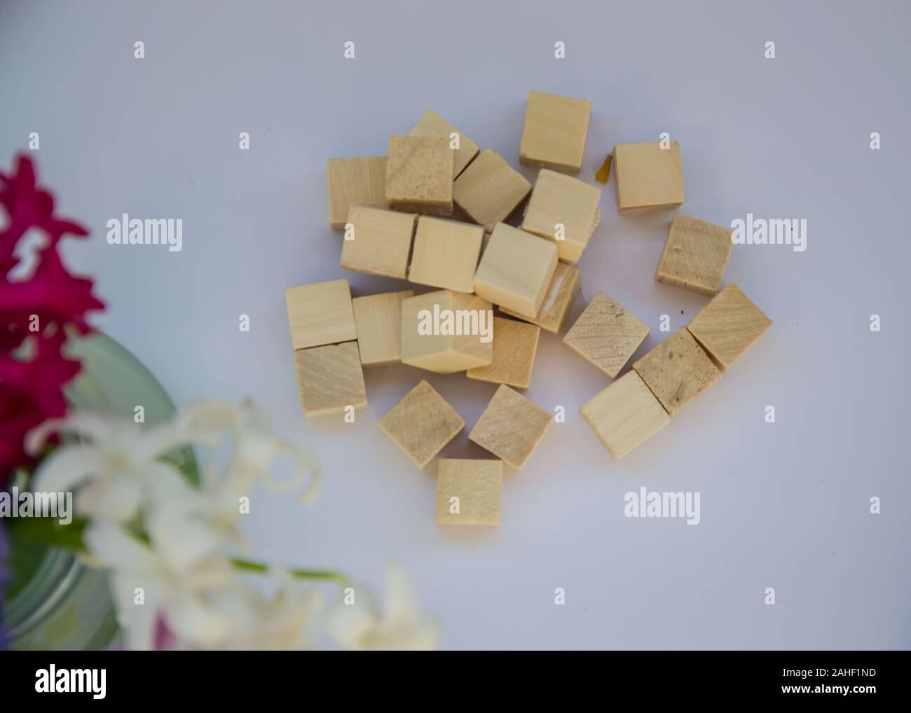 Pile of wooden blocks on pale purple background, small cubes made from ...