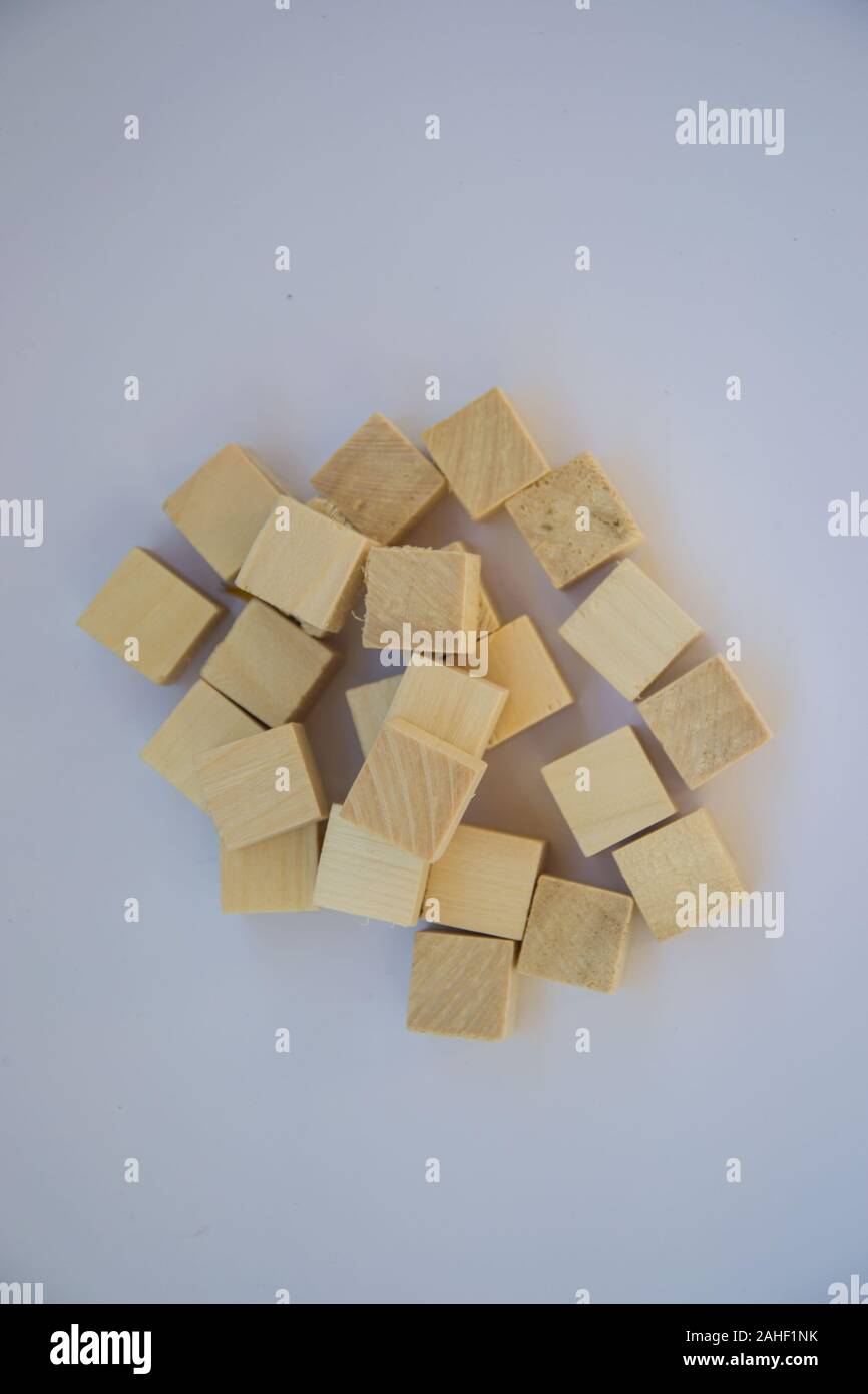 Pile of wooden blocks on pale purple background, small cubes made from ...