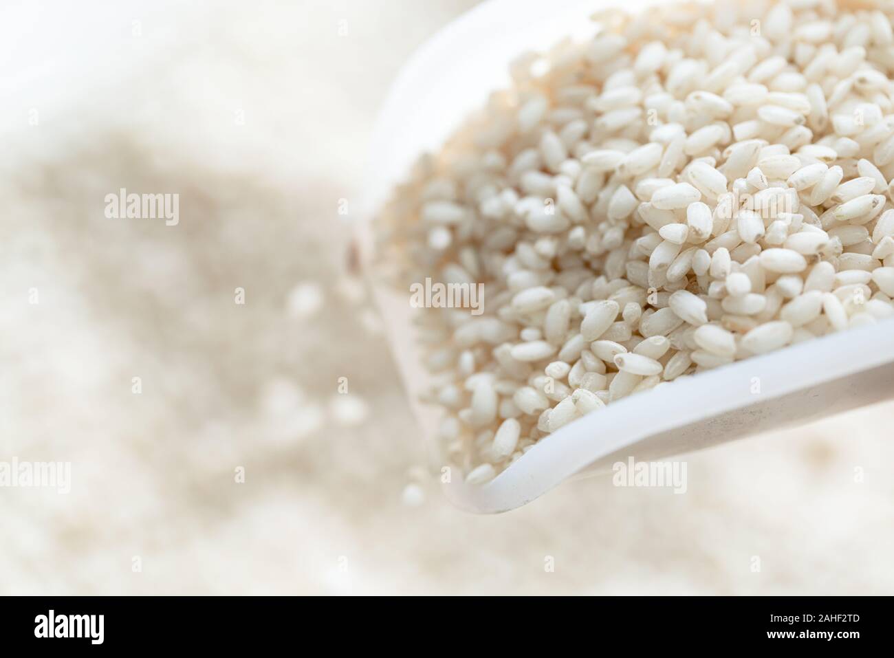 seeds Short rice with spoon on rice background,Close up Stock Photo - Alamy