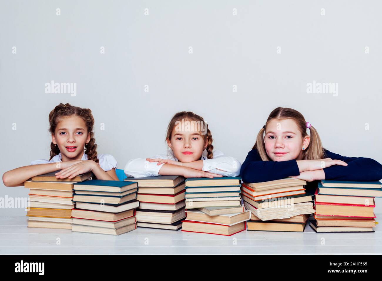 three girls at school in the classroom for books of knowledge Stock ...
