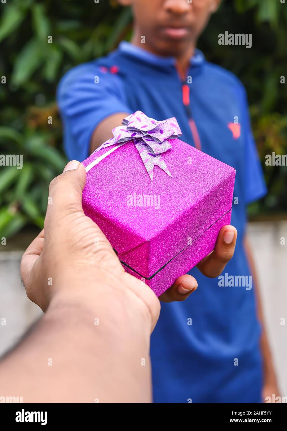 Hands giving and receiving a presents Stock Photo - Alamy
