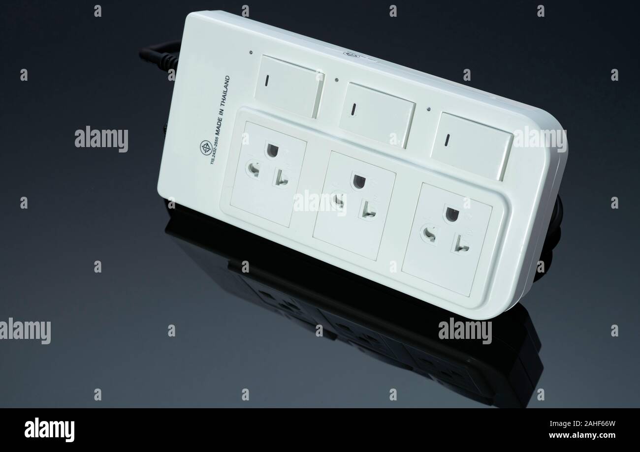 Power strip with three electrical standard socket on black background ...
