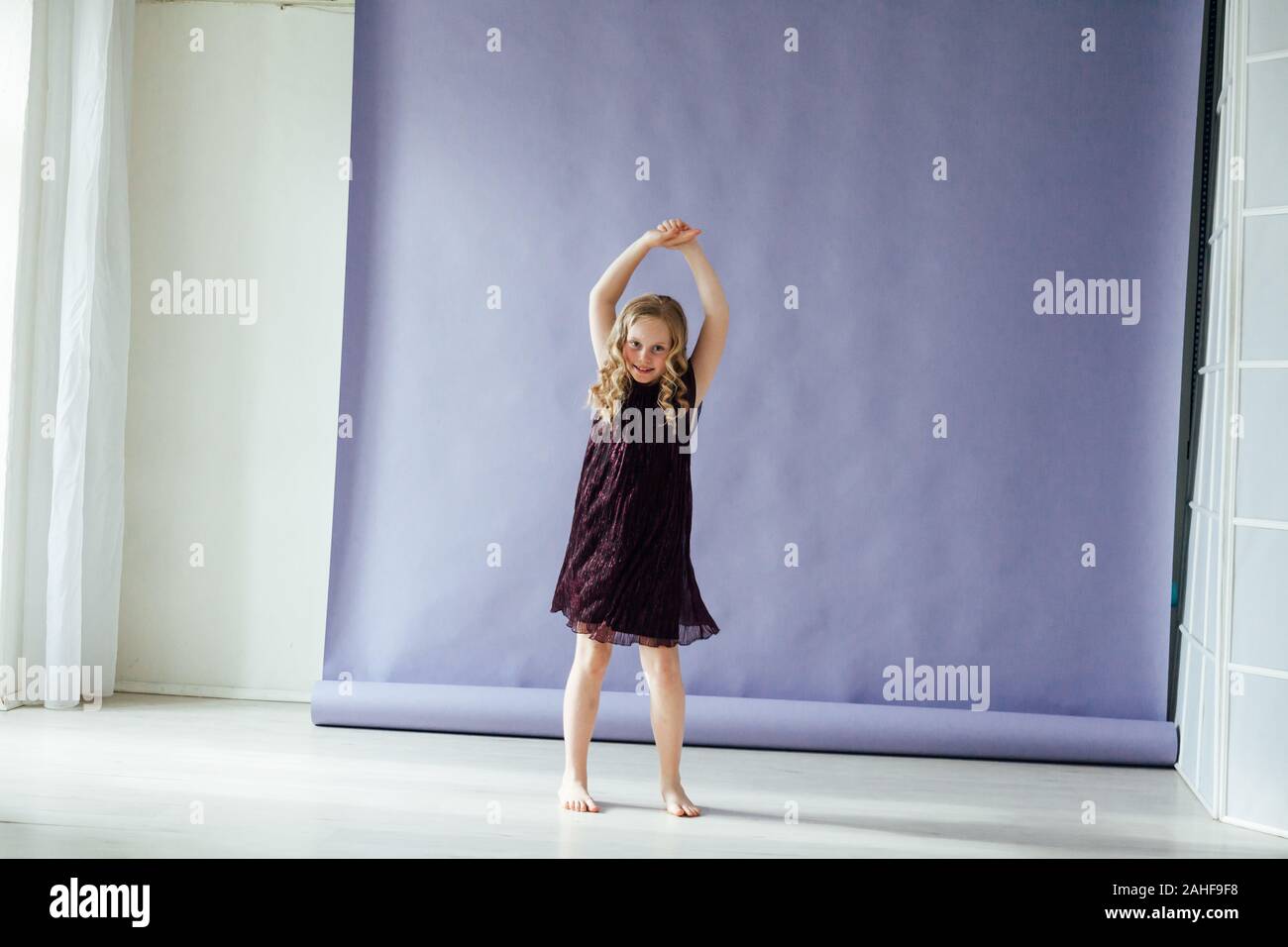Beautiful little girl blonde dancing music alone Stock Photo - Alamy