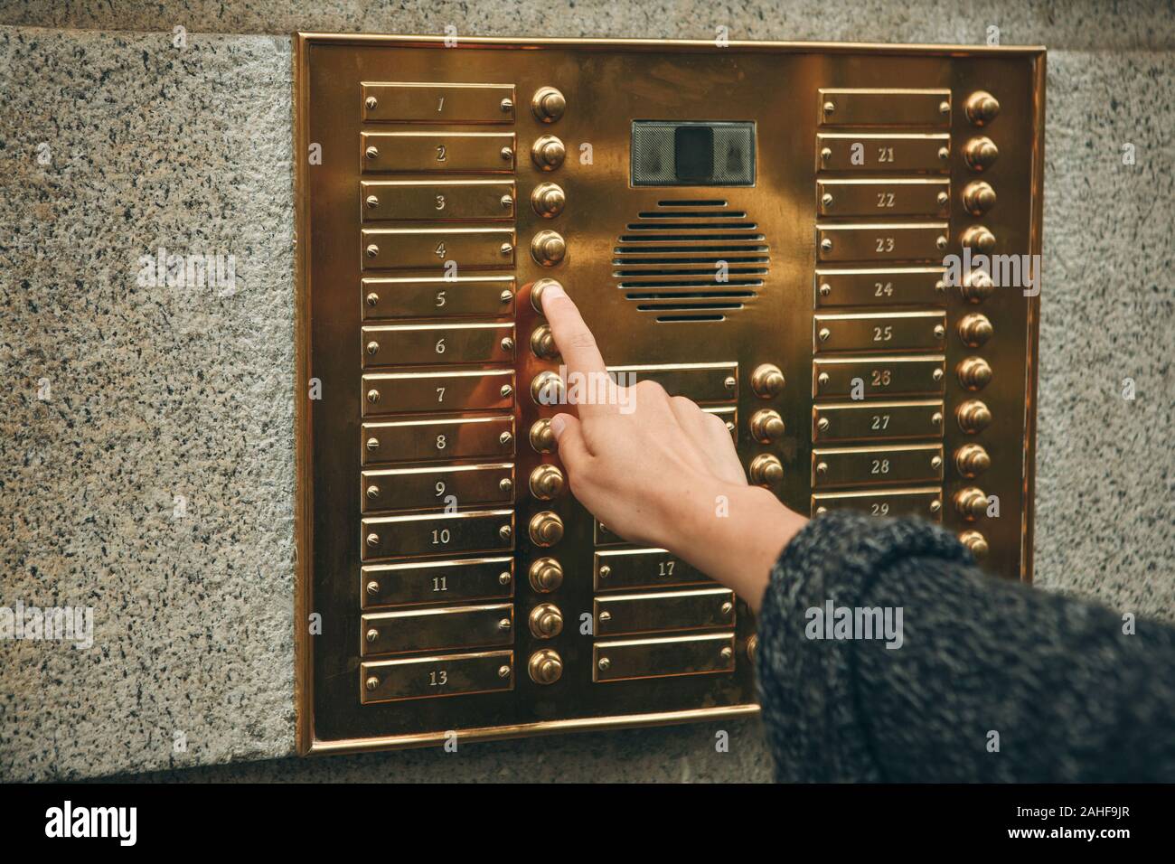 Female hand presses the intercom button to access inside Stock Photo ...