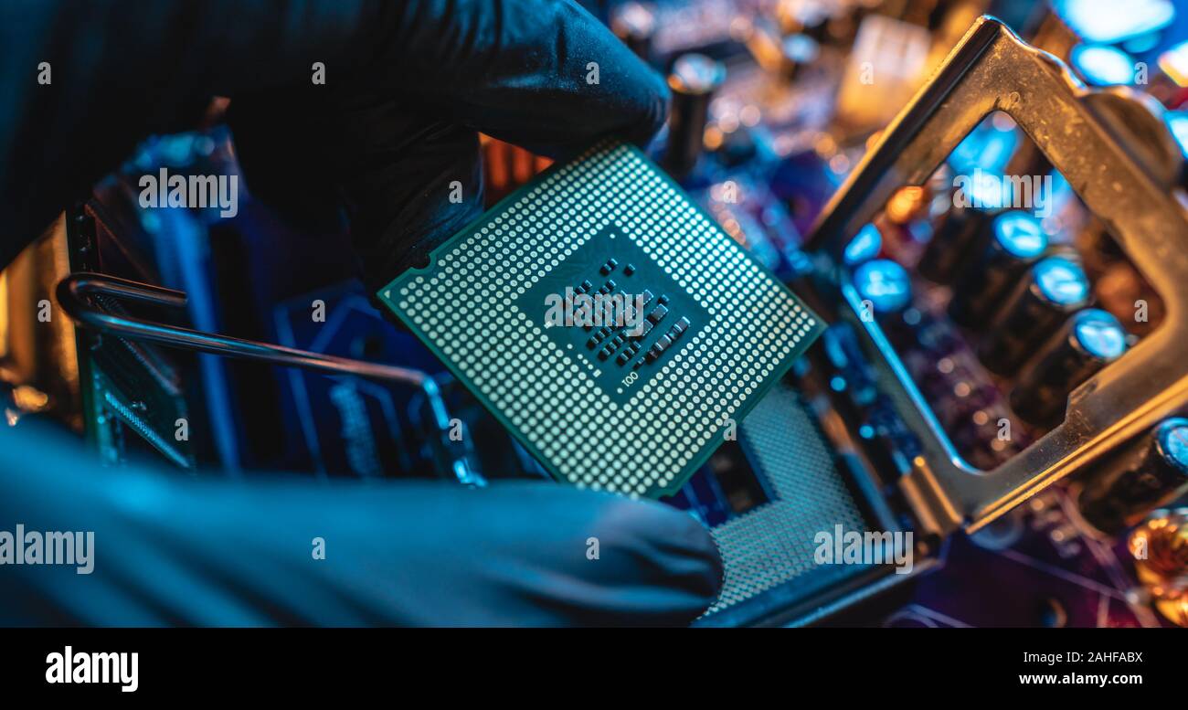 Engineer repairman holding hands in black gloves chip processor, CPU to ...