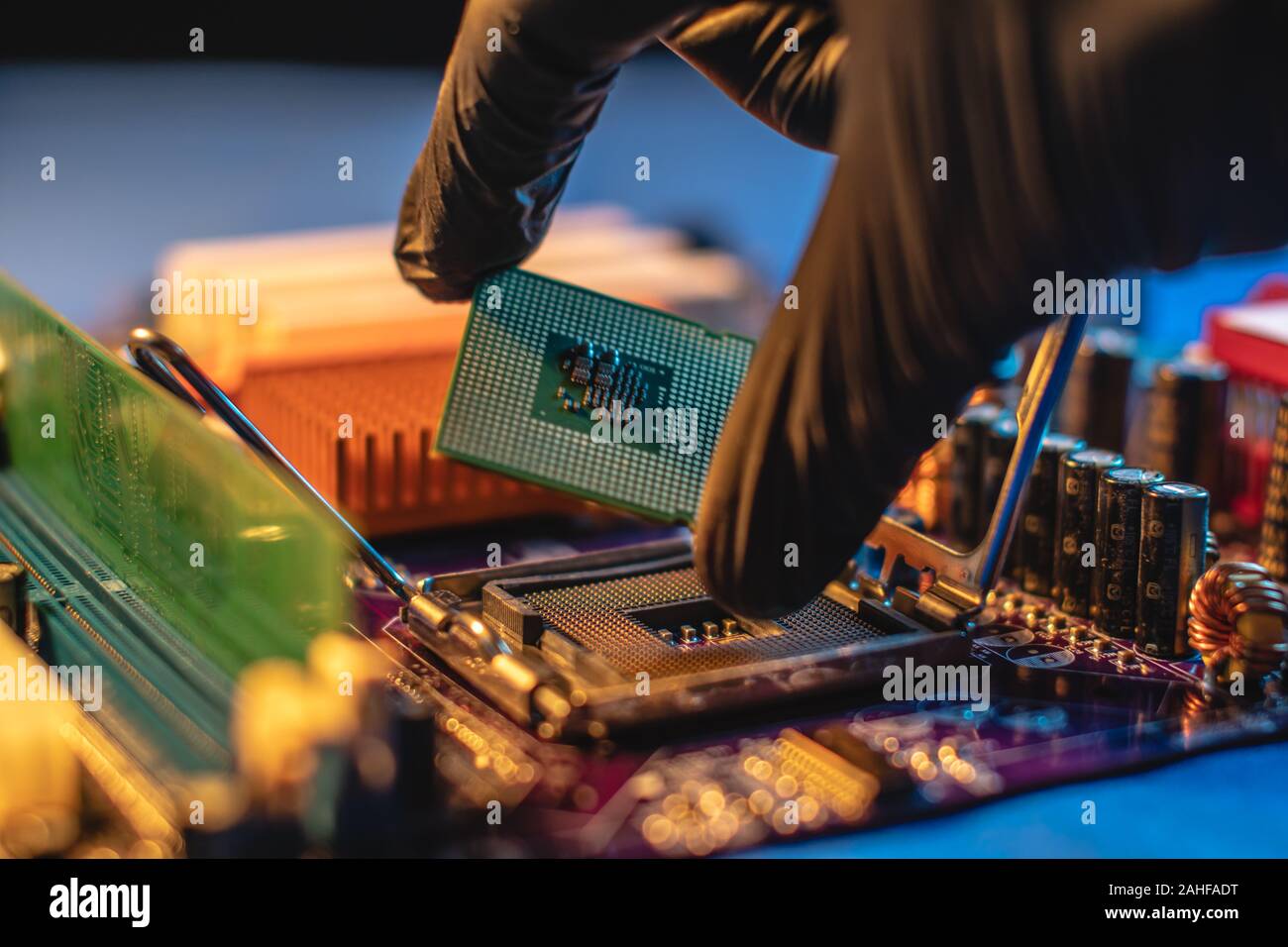 Engineer repairman holding hands in black gloves chip processor, CPU to ...