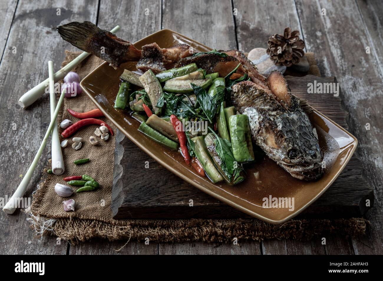 Deep fried whole Snakehead with Spicy stir fry eggplant, Thai food for ...