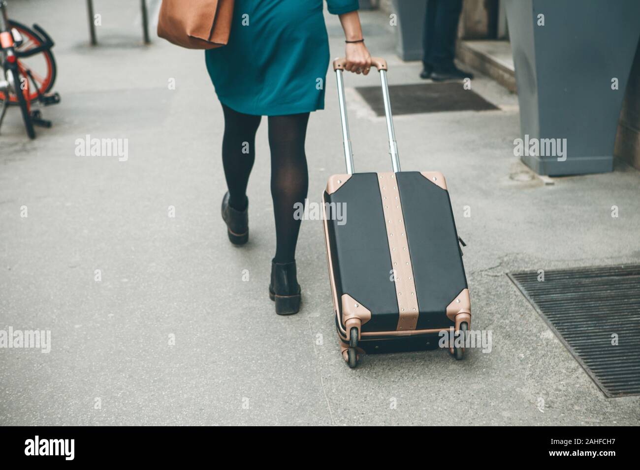 Woman walking way suitcase hi-res stock photography and images - Alamy