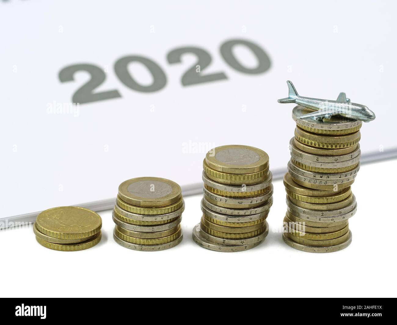 silver miniature air plane on stack of euro coins, concept of rising ...