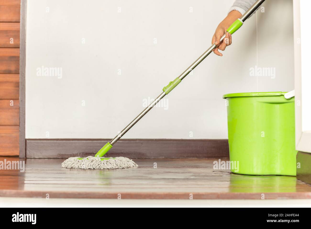 Woman's hand holding a mop cleaning house floor Stock Photo - Alamy