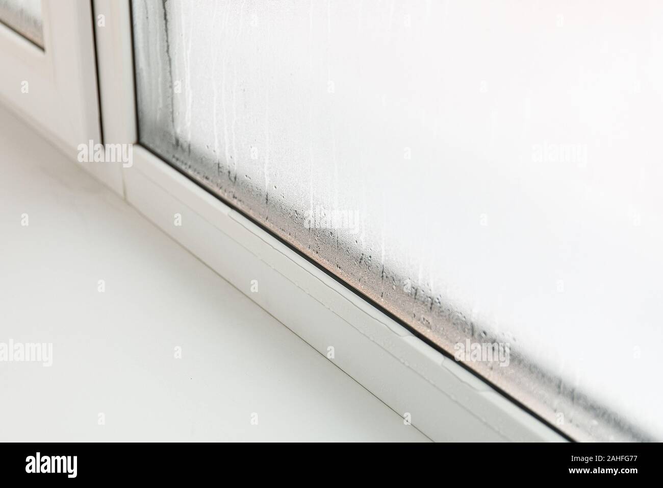 Plastic window with damp and water condensation on glass. Bad ...