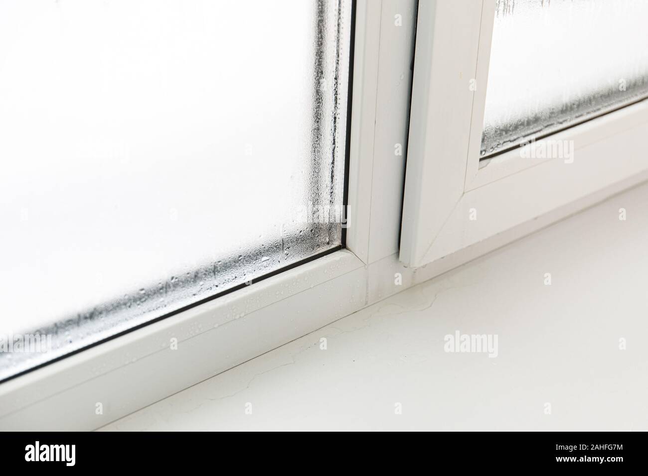 Plastic window with damp and water condensation on glass. Bad ...