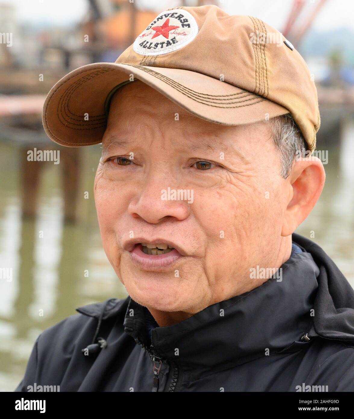 Older Vietnamese man who works as a waiter and tour guide Stock Photo ...
