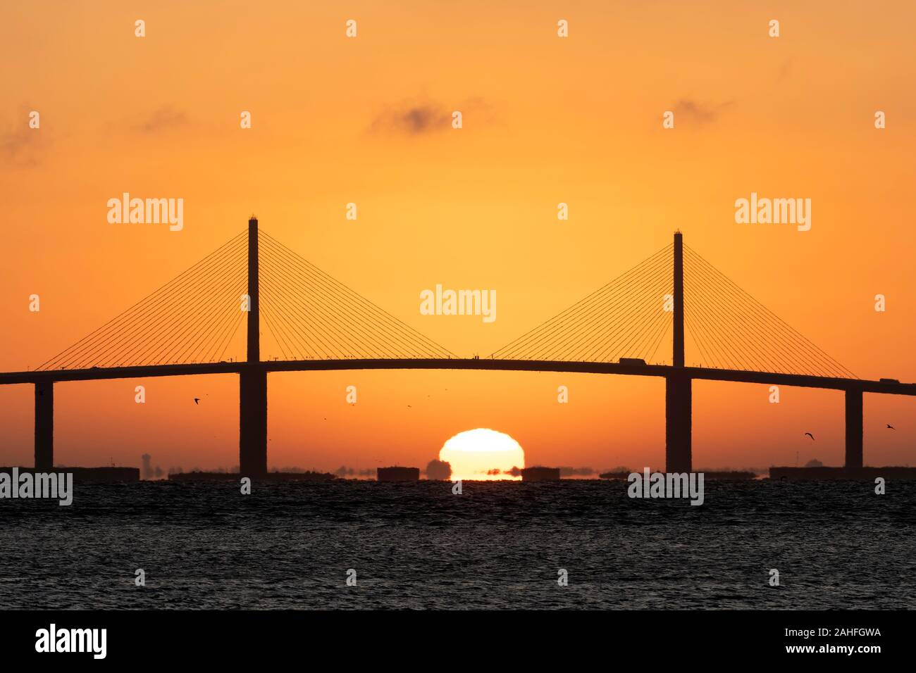 Bridge as the sun rises in the Gulf of Mexico Stock Photo - Alamy