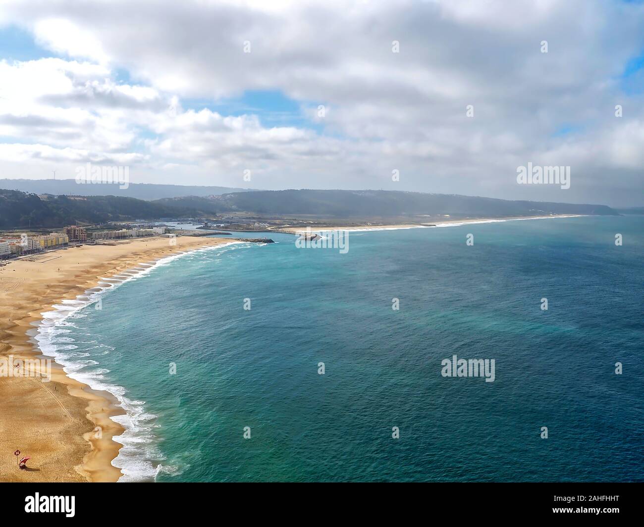 Beach, turquoise ocean, waves and sea in Nazare in the Centro region of ...