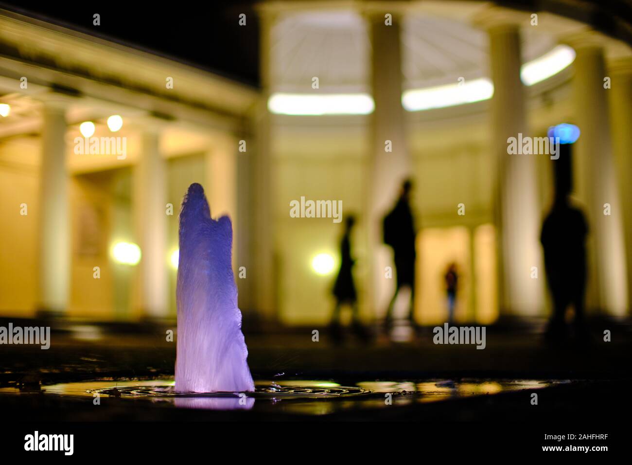 Illuminated water in front of "Elisenbrunnen" fountain in the heart of ...