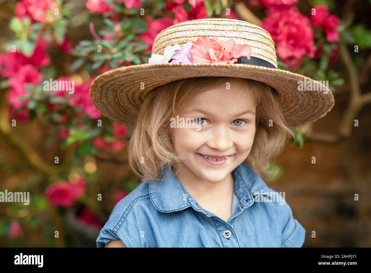 Child planting spring flowers. Little girl gardener plants azalea. Girl ...