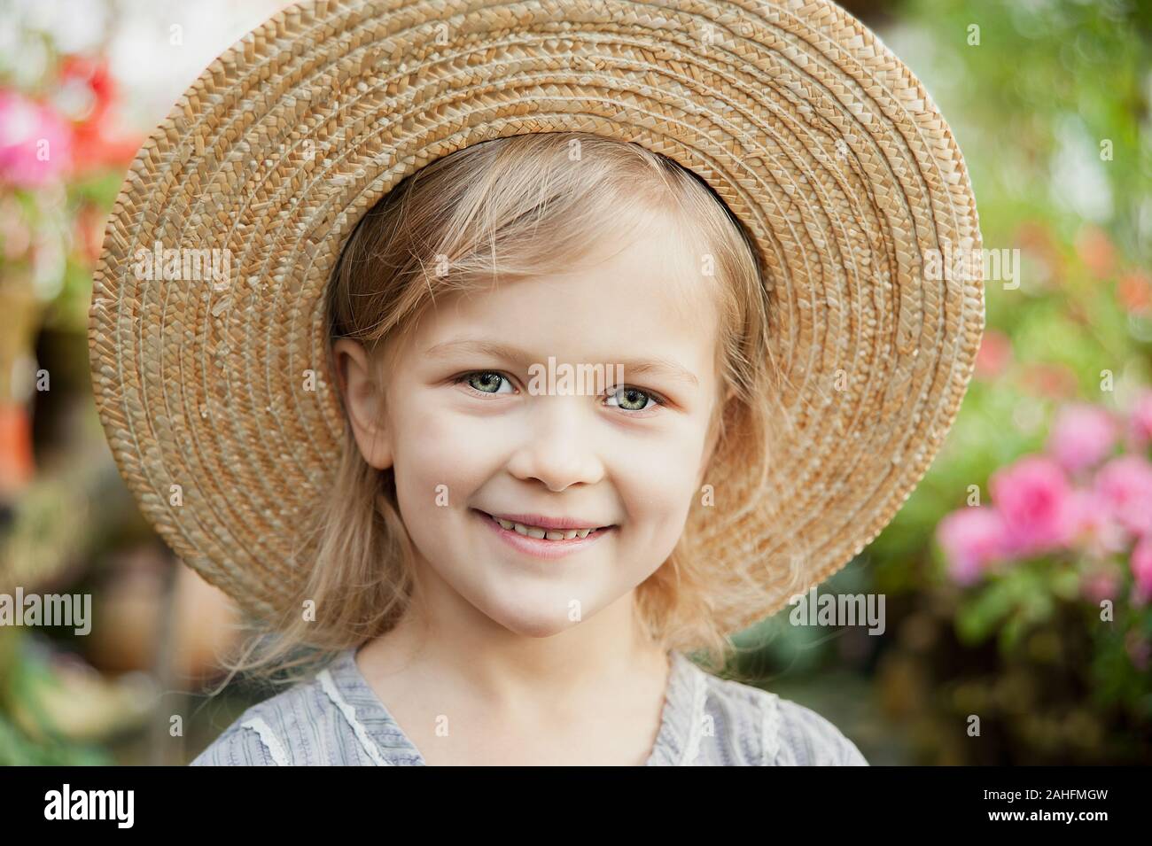 Child planting spring flowers. Little girl gardener plants azalea. Girl ...