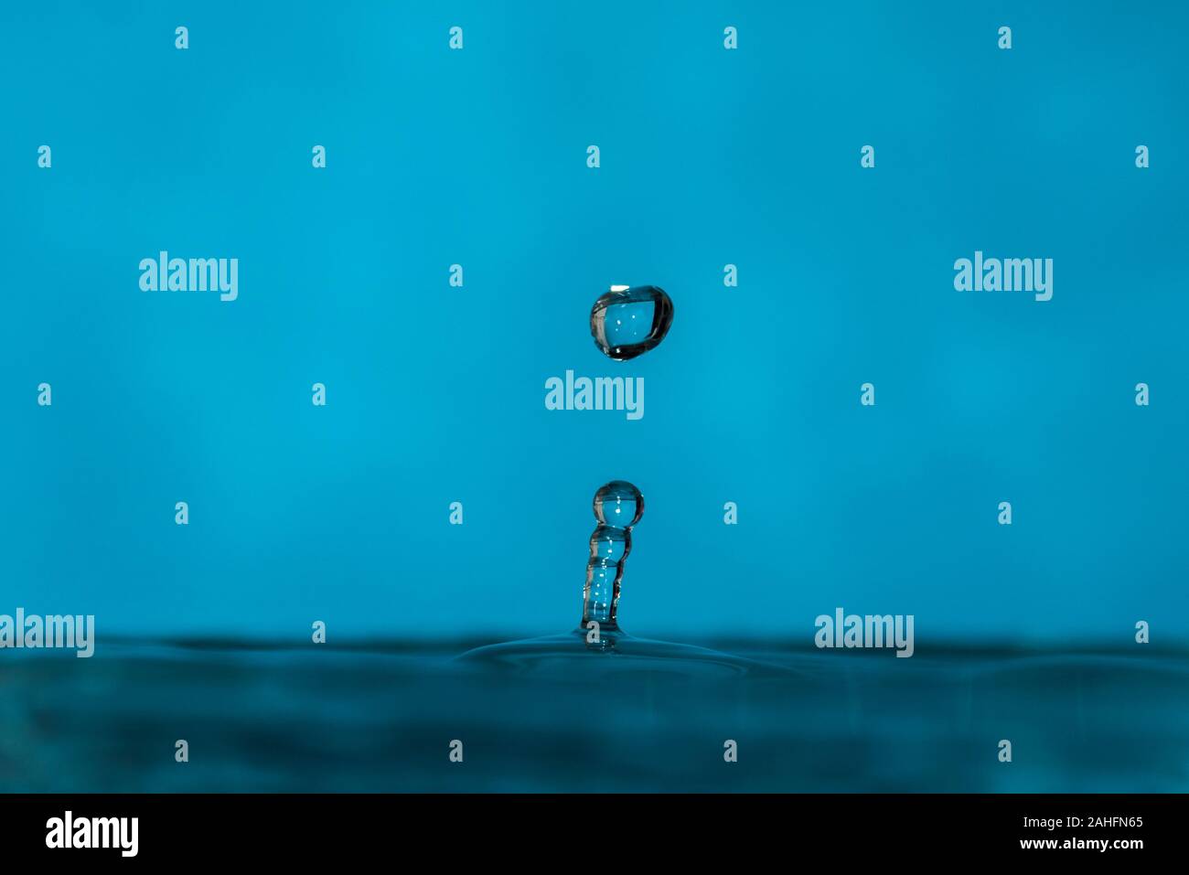 water drops splash forming ripples and waves and abstract water columns ...