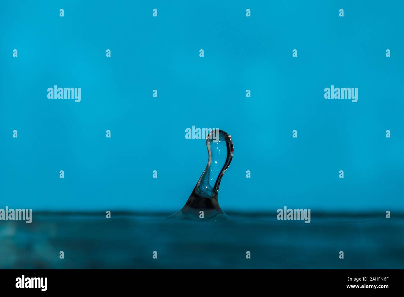 water drops splash forming ripples and waves and abstract water columns ...