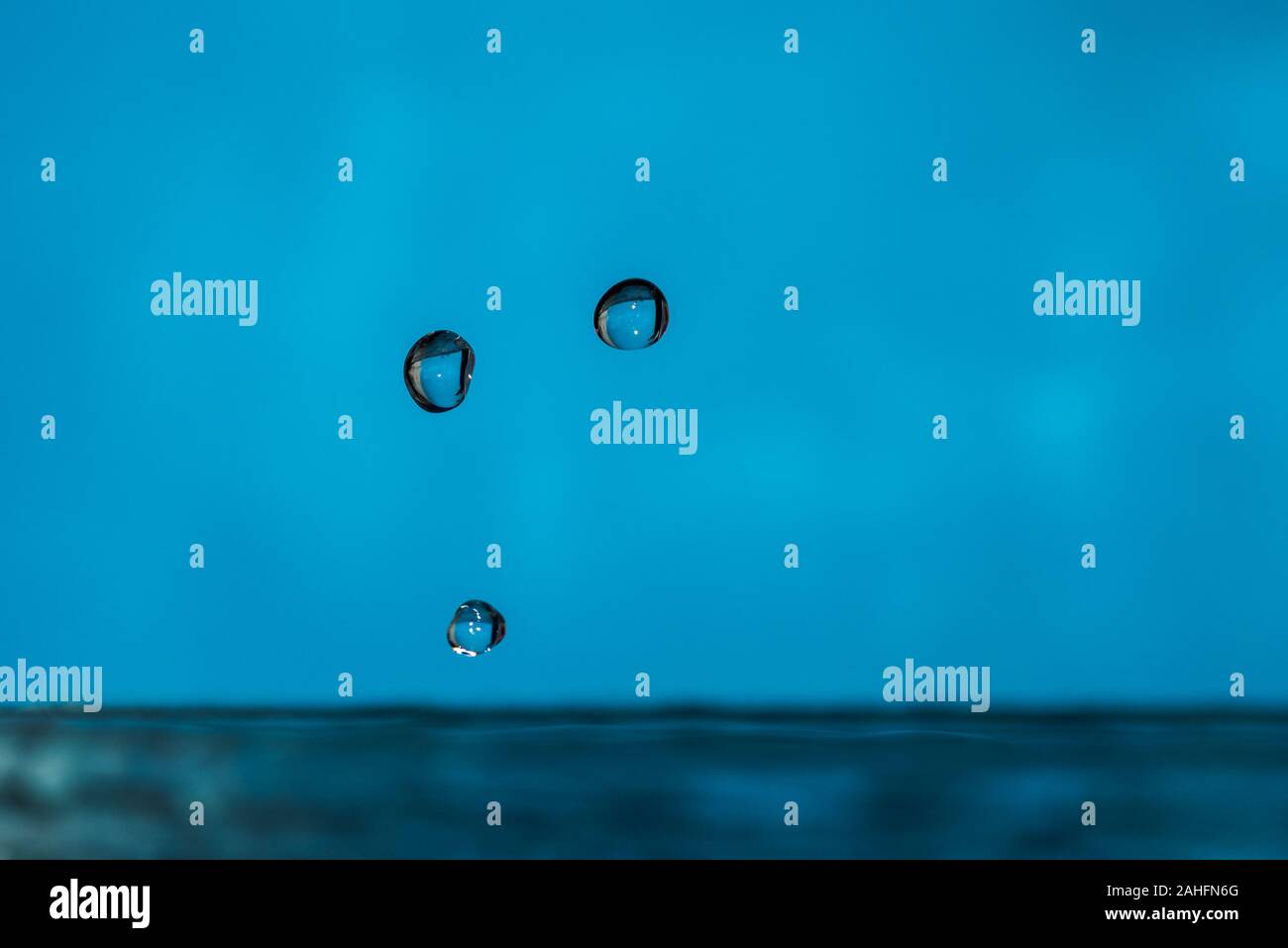 water drops splash forming ripples and waves and abstract water columns ...