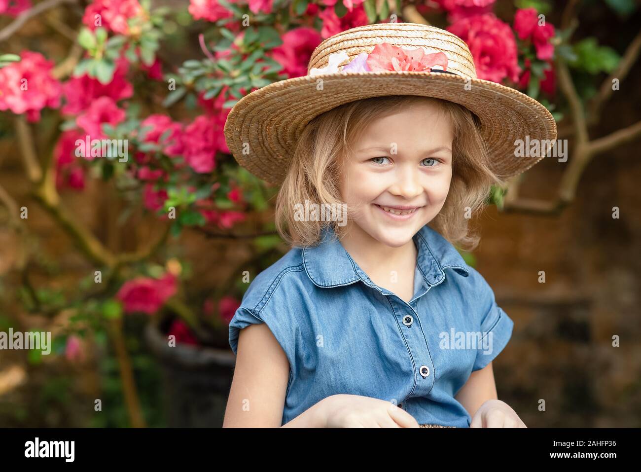 Child planting spring flowers. Little girl gardener plants azalea. Girl ...