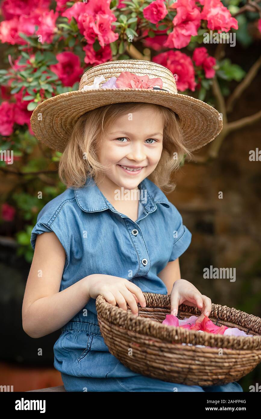 Child planting spring flowers. Little girl gardener plants azalea. Girl ...