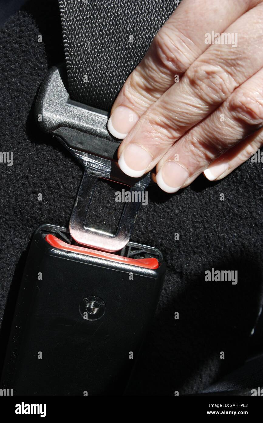 A view from behind the driver of a vehicle, wearing a seat belt. In ...