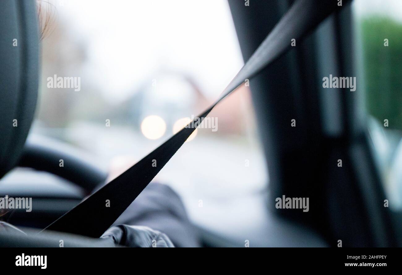 A view from behind the driver of a vehicle, wearing a seat belt. In ...