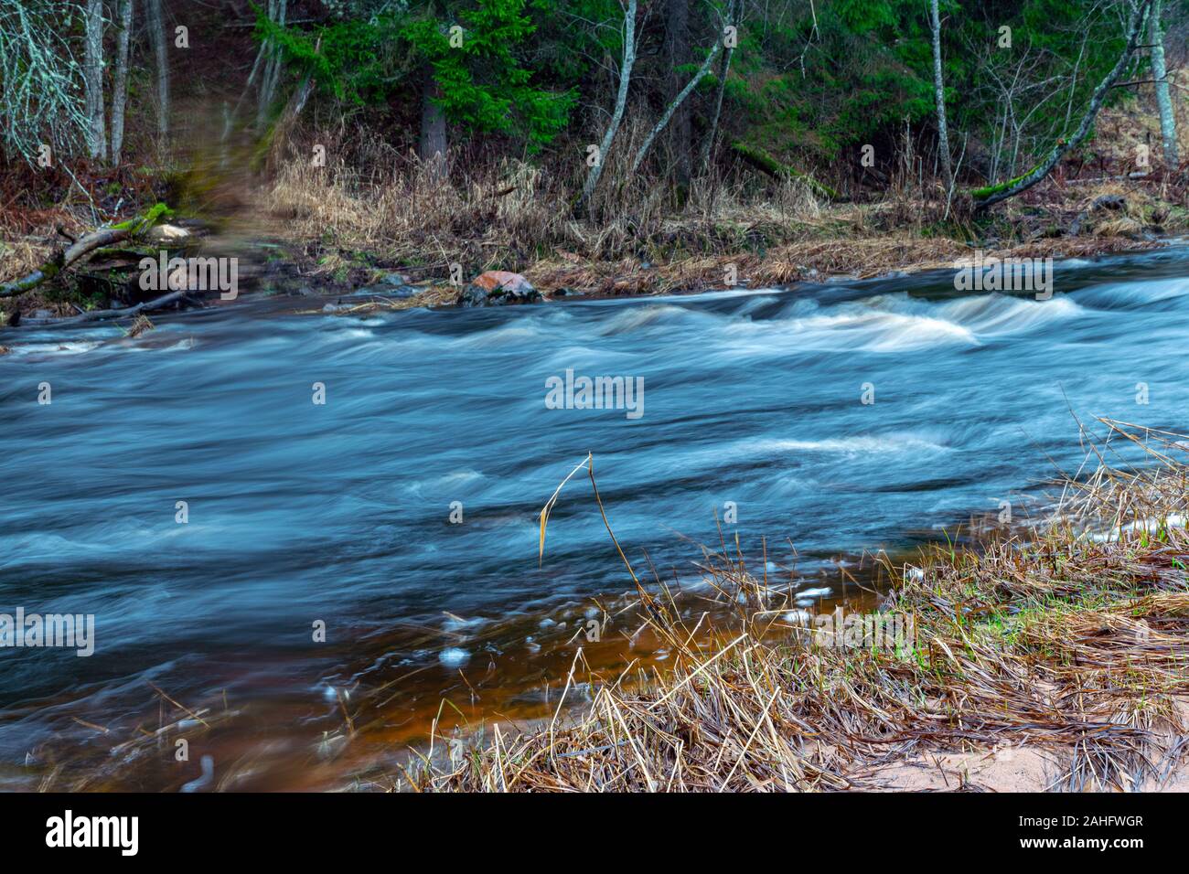abstract blurry water texture, a steep river in the evening chair ...